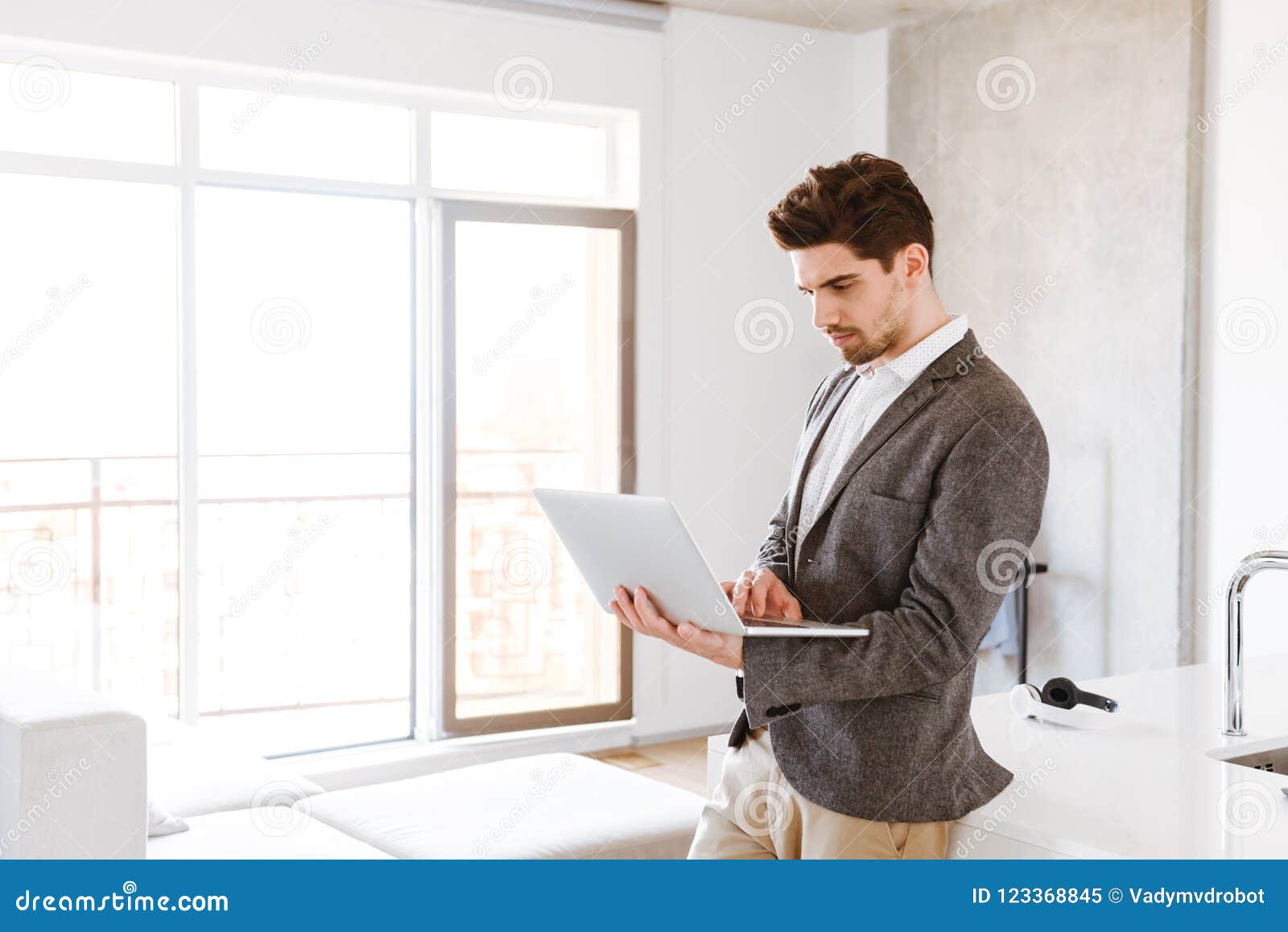 Serious Young Man in Suit Using Laptop Computer Stock Image - Image of ...