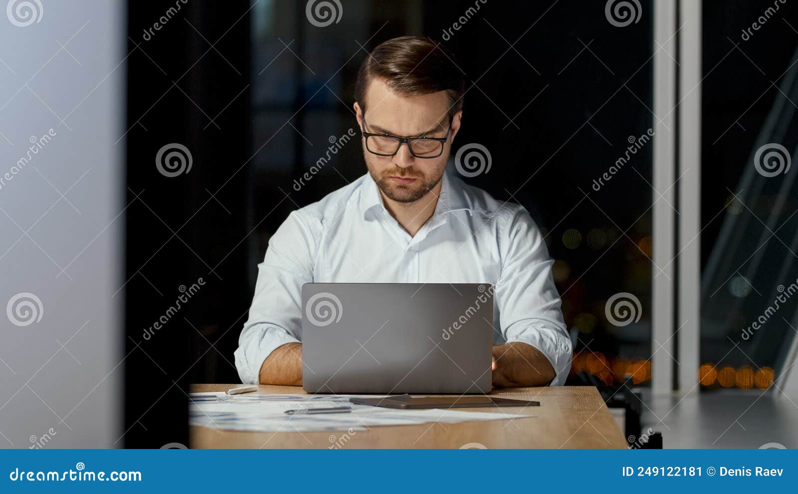 Serious Young Man Typing Message on Laptop Keyboard in Office Stock ...