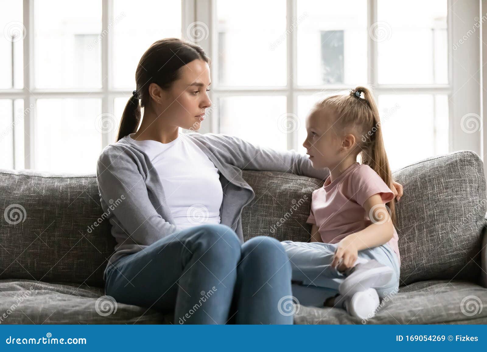 Serious Mother Talk With Small Daughter In Living Room Stock Image