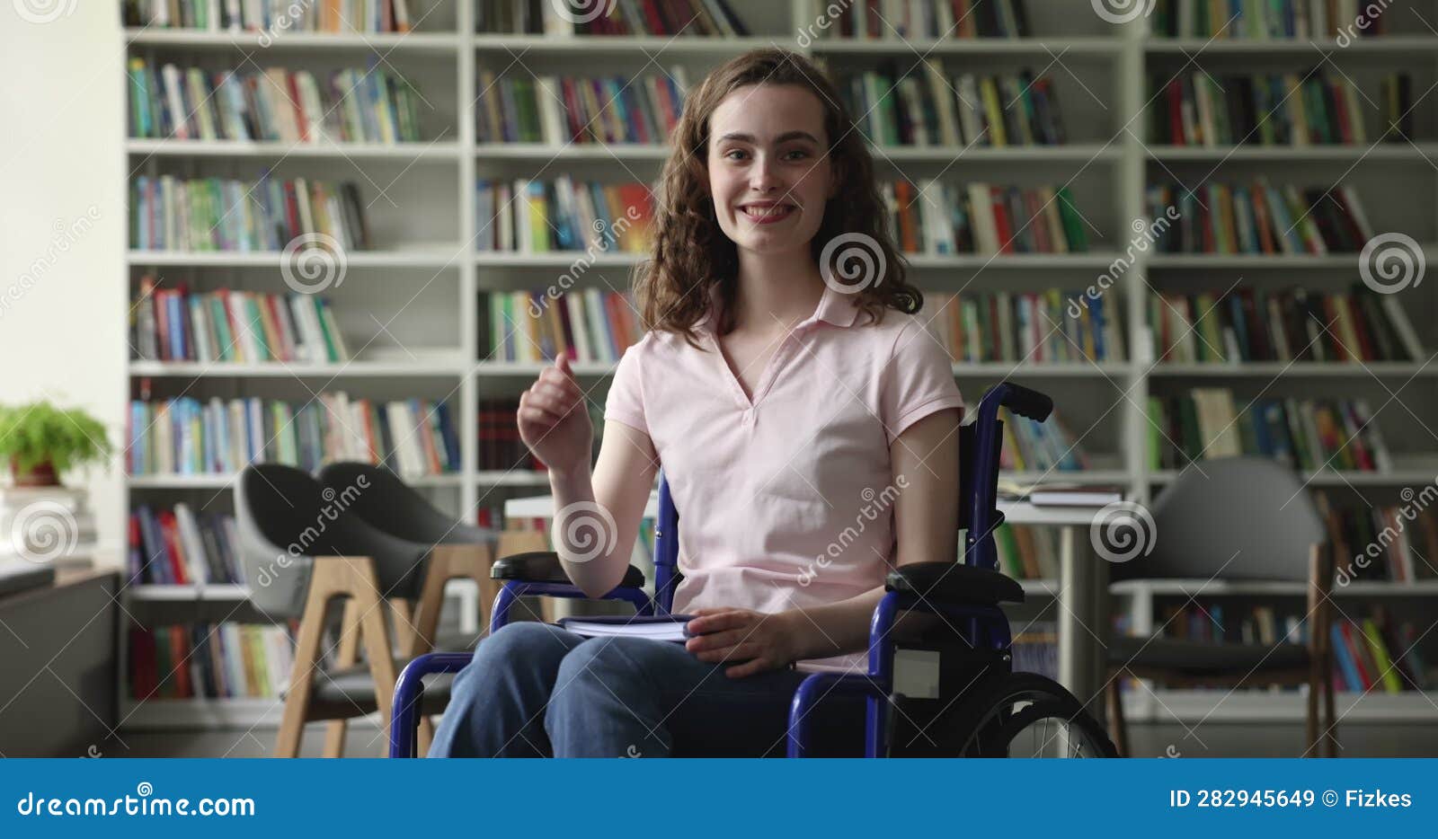 Serious Young Student with Disability Using Wheelchair, Posing in ...