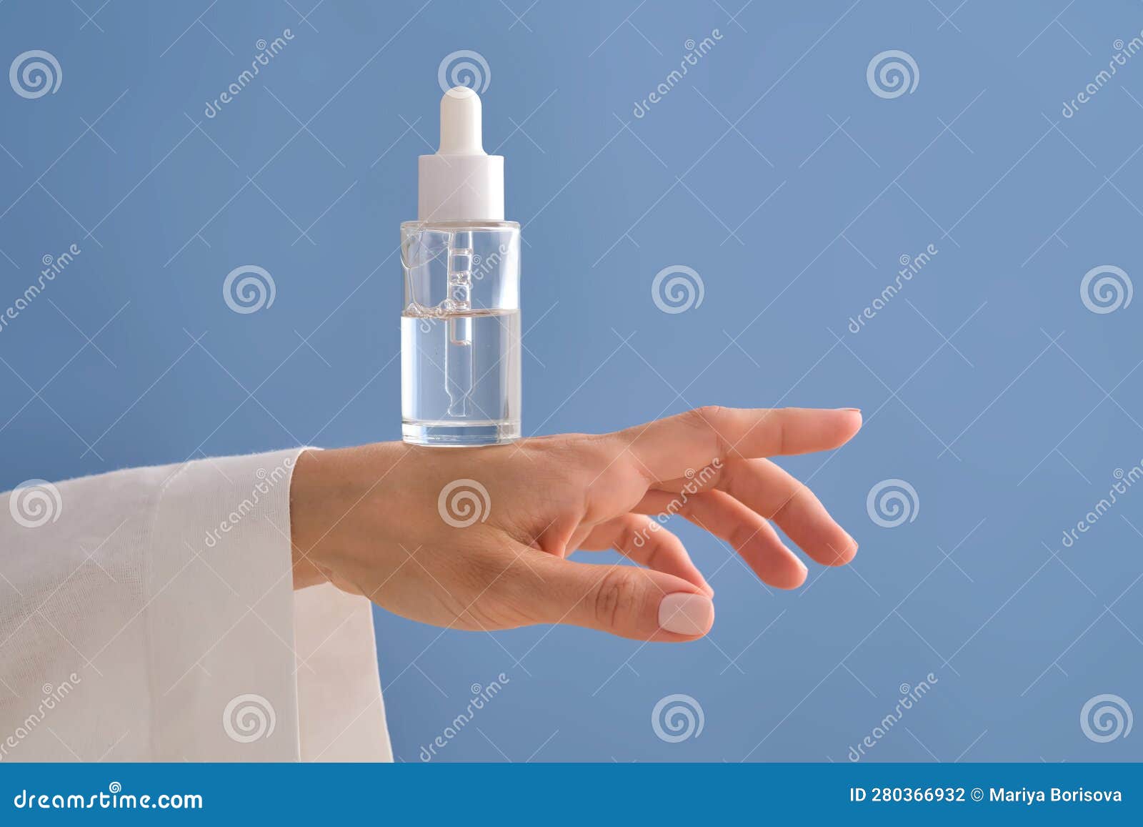 Serum with a Pipette in Female Hands on a Blue Background. Stock Photo ...