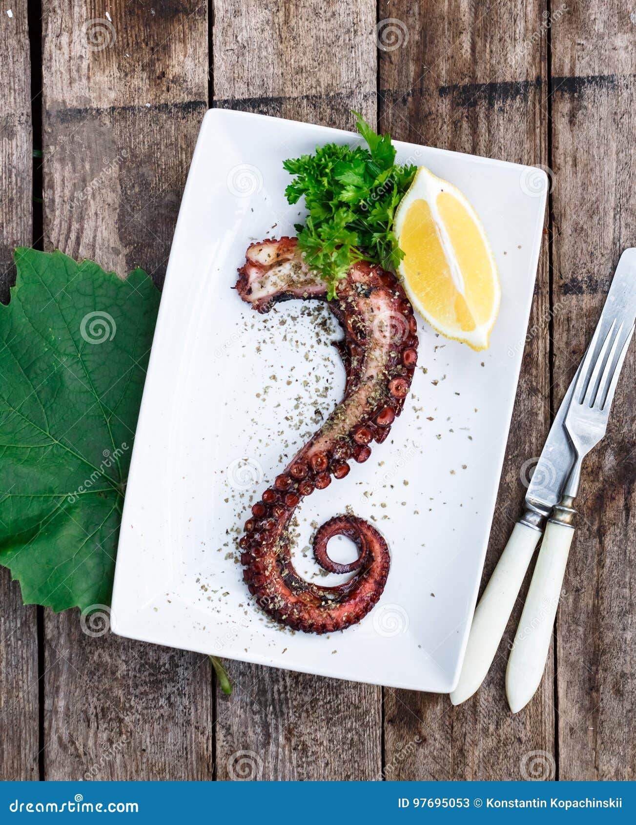 Served Octopus Tentacle on White Plate with Lemon and Oregano Stock ...