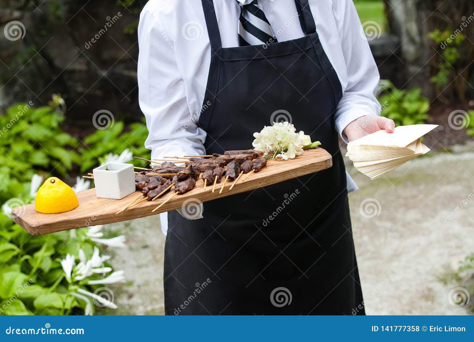 A Server Holding a Wooden Tray Full of Meat Snacks during a Catered ...
