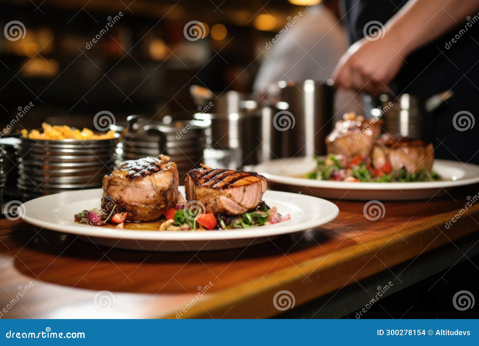 Server Placing Grilled Pork Chops on Diners Plates Stock Photo - Image ...