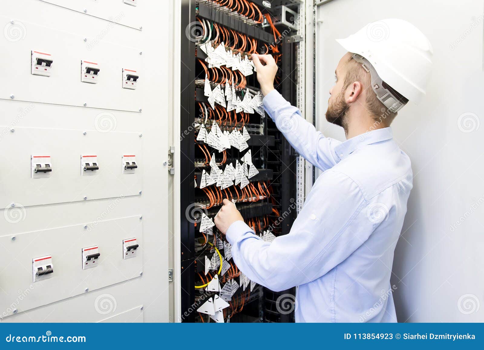 Service Engineer in the Data Center. Worker in a Helmet Near the ...