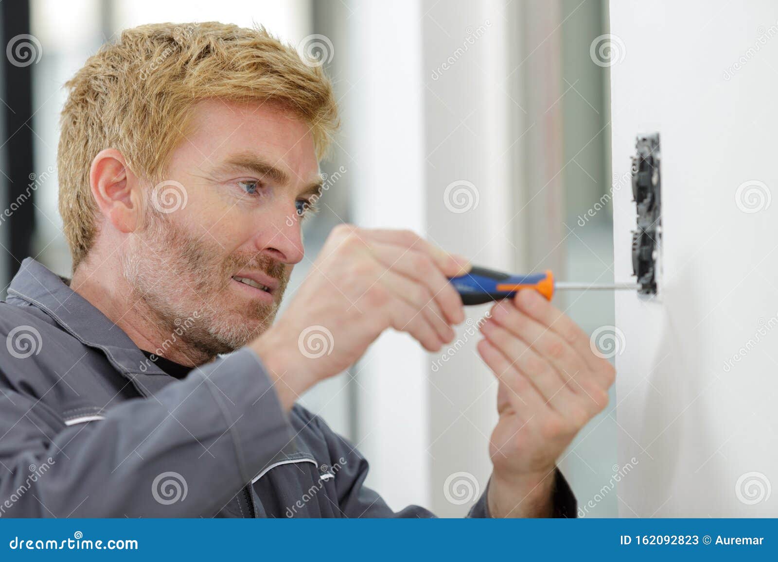 Service Man Installing Power Socket in Wall Stock Image - Image of ...