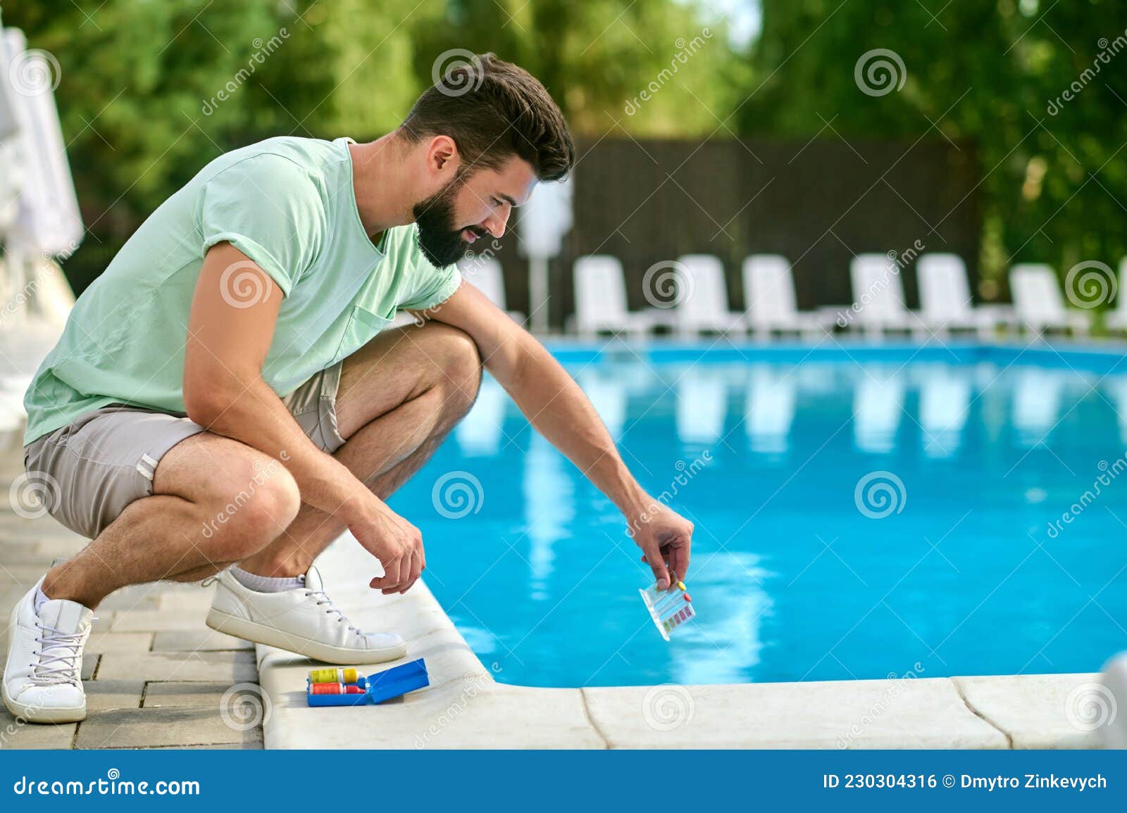 A Service Man Making a Water Test in a Swimming Pool Stock Photo ...
