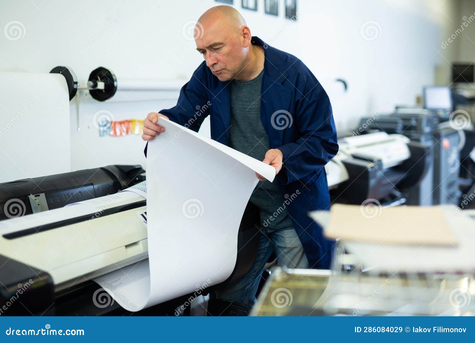 Service Man Uses Plotter and Checks Functionality in Printing Shop ...