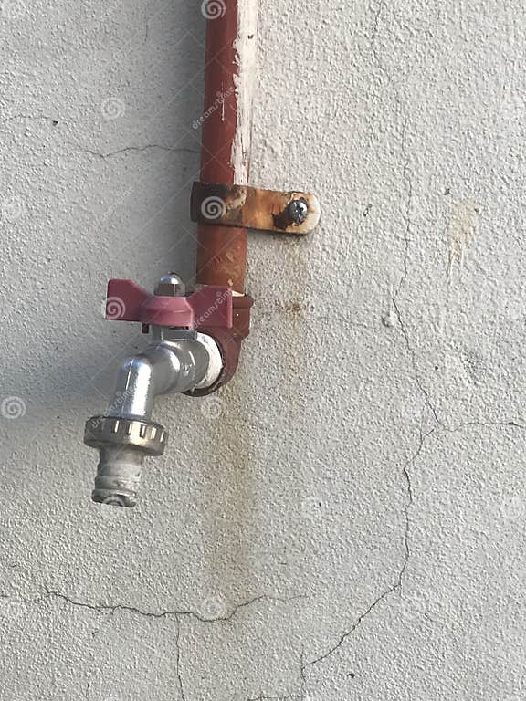Service Tap on a Wall of a House Stock Photo - Image of flowing ...