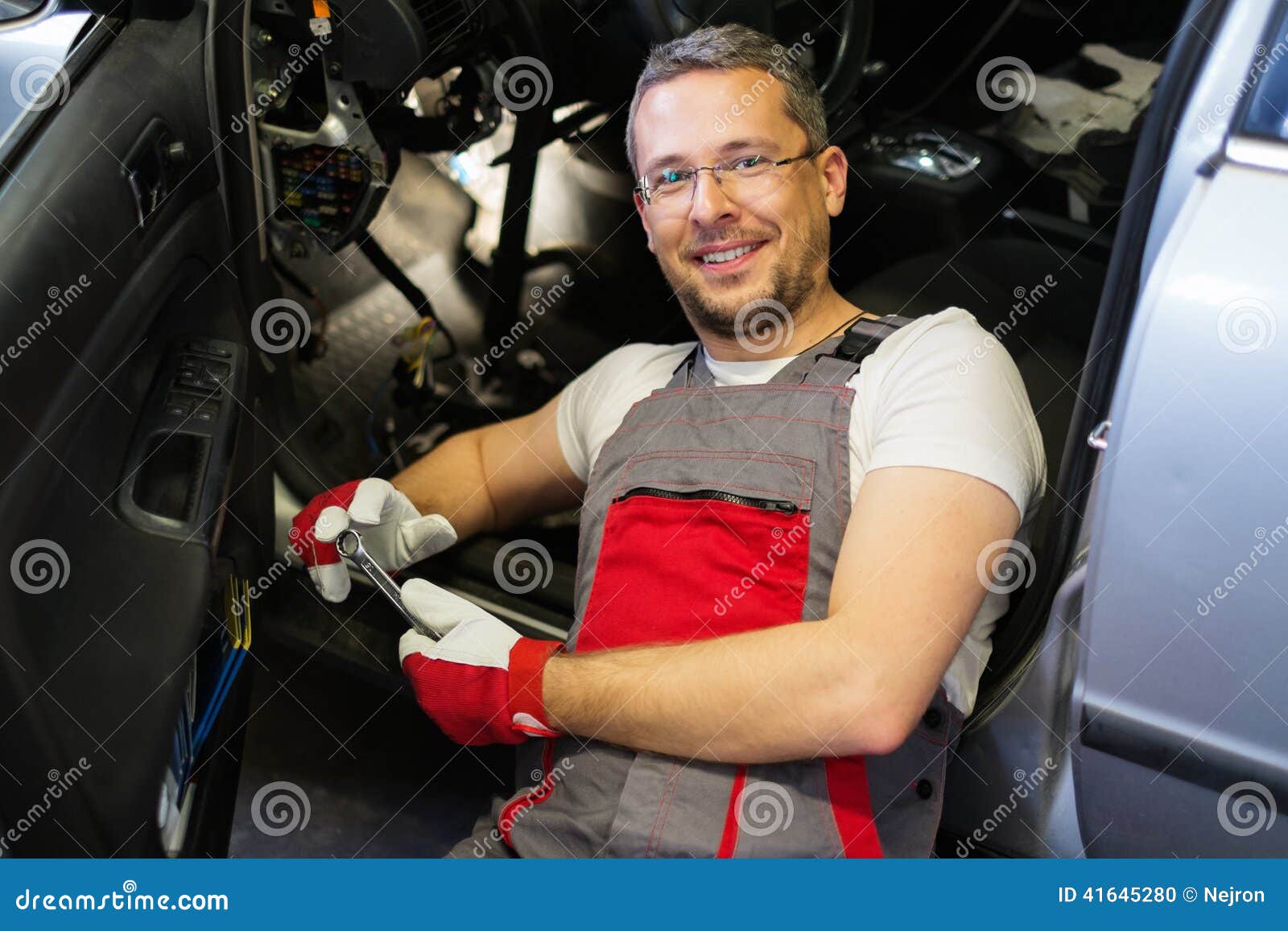 Serviceman in car workshop stock photo. Image of industry - 41645280