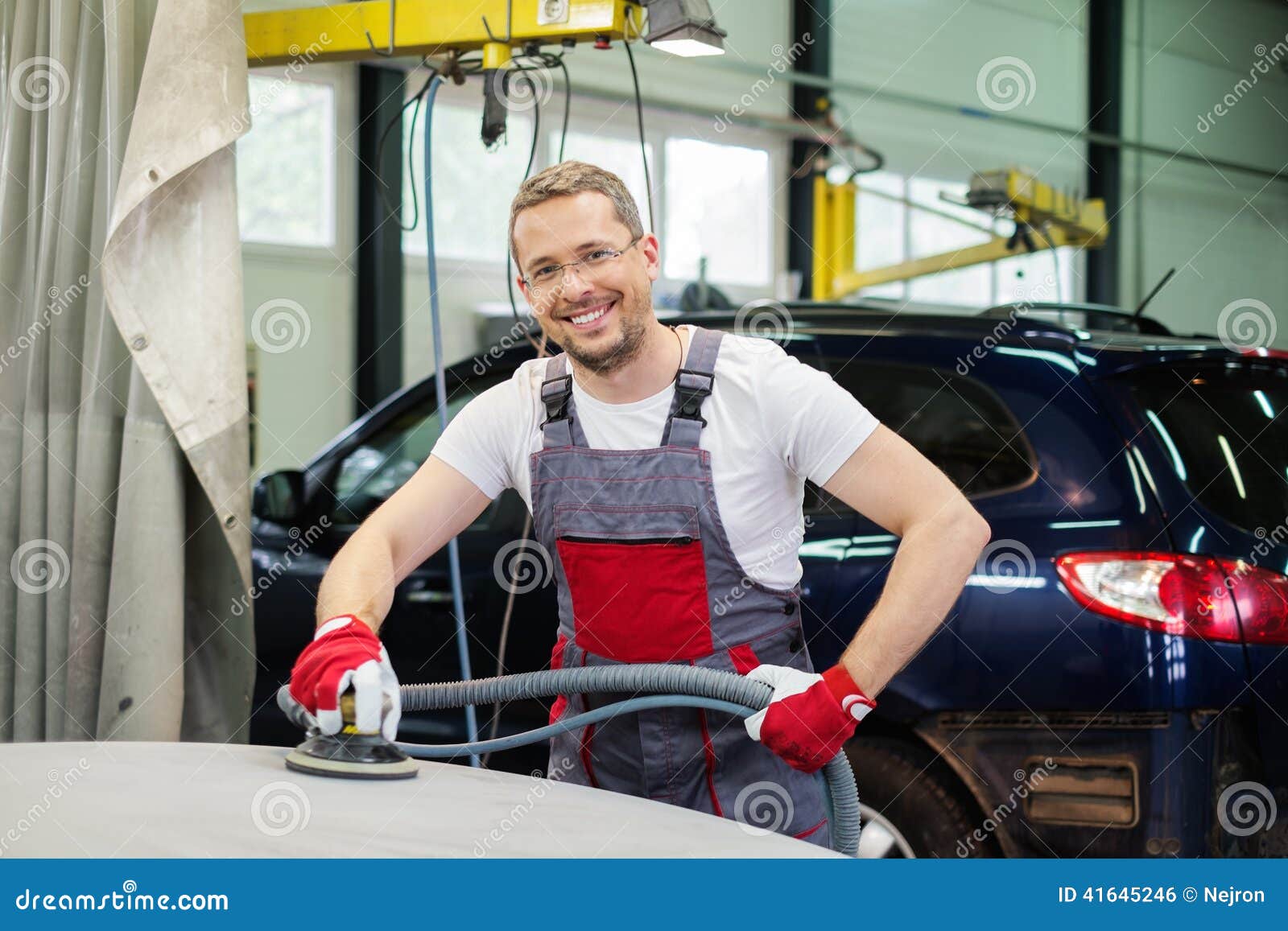 Serviceman in car workshop stock photo. Image of paint - 41645246