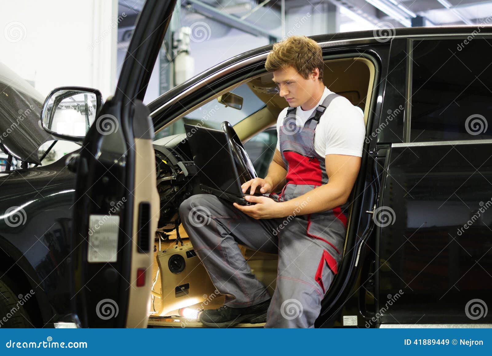 Serviceman in a Car Workshop Stock Image - Image of change, repairman ...