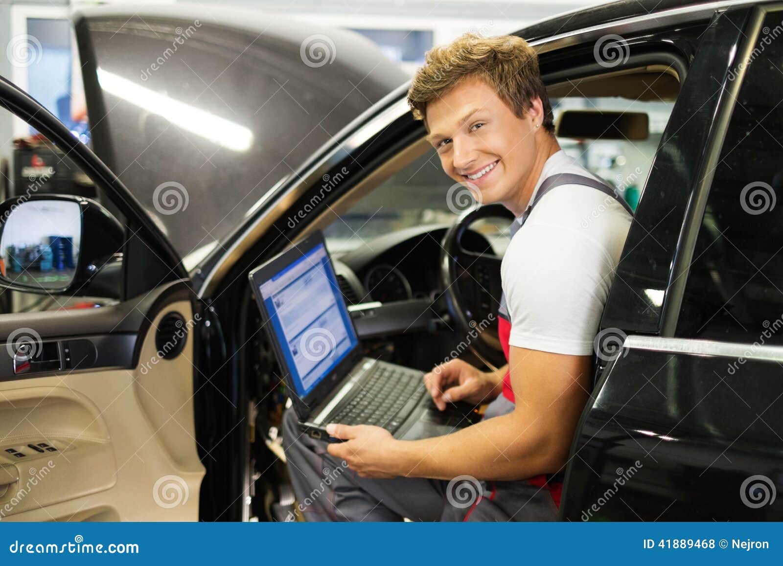 Serviceman in a Car Workshop Stock Photo - Image of profession, broken ...