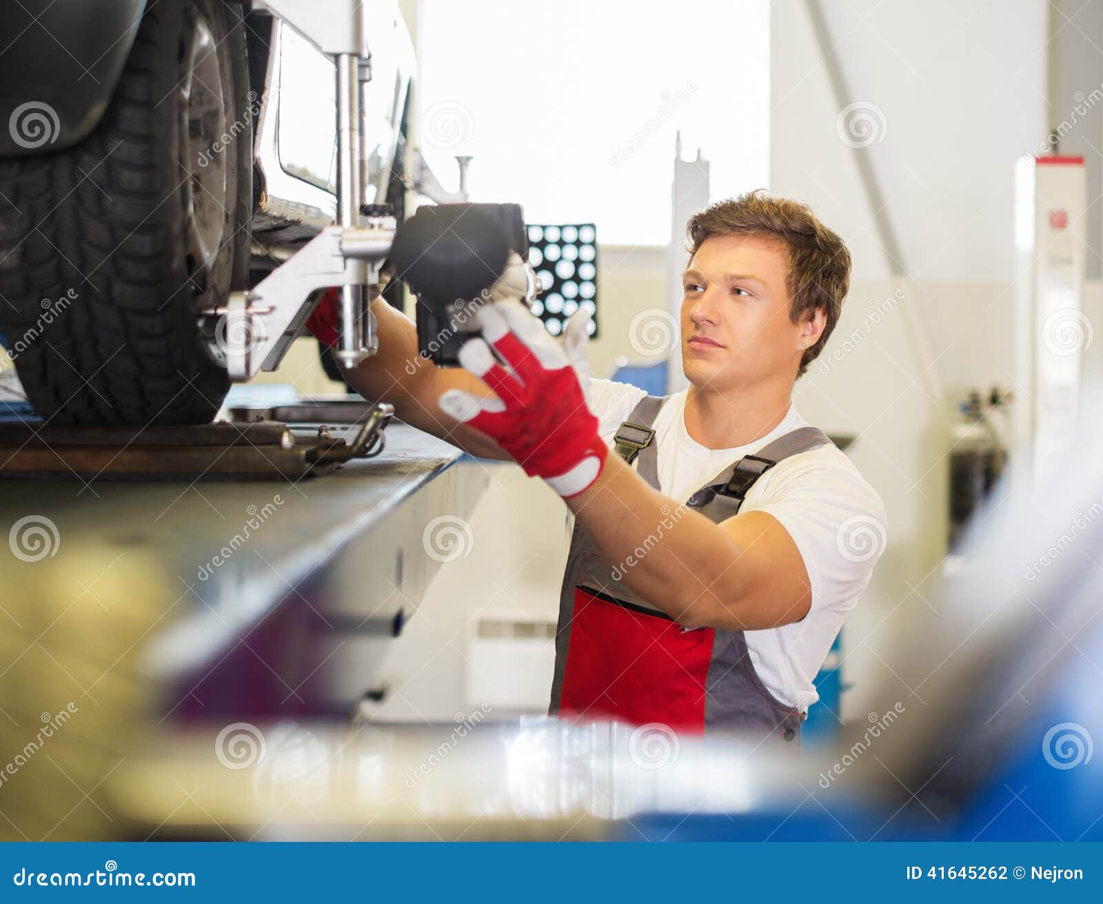 Serviceman in car workshop stock photo. Image of check - 41645262