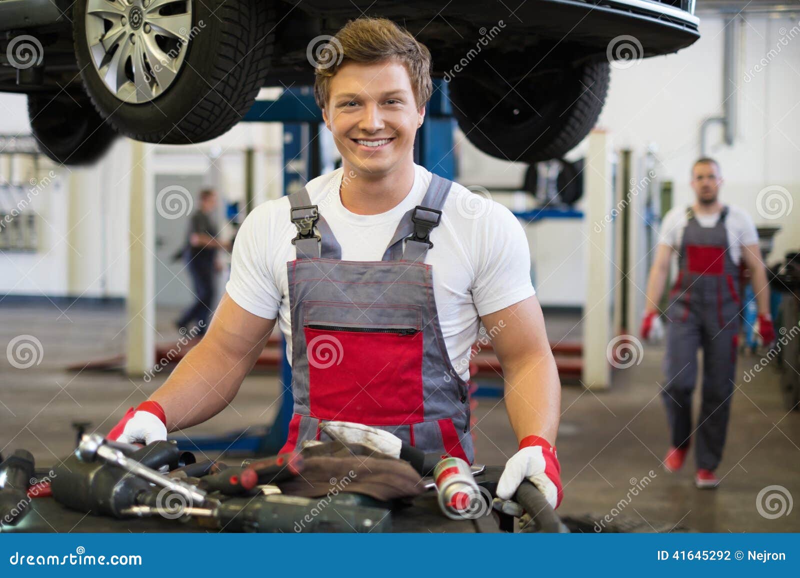 Serviceman in car workshop stock photo. Image of profession - 41645292
