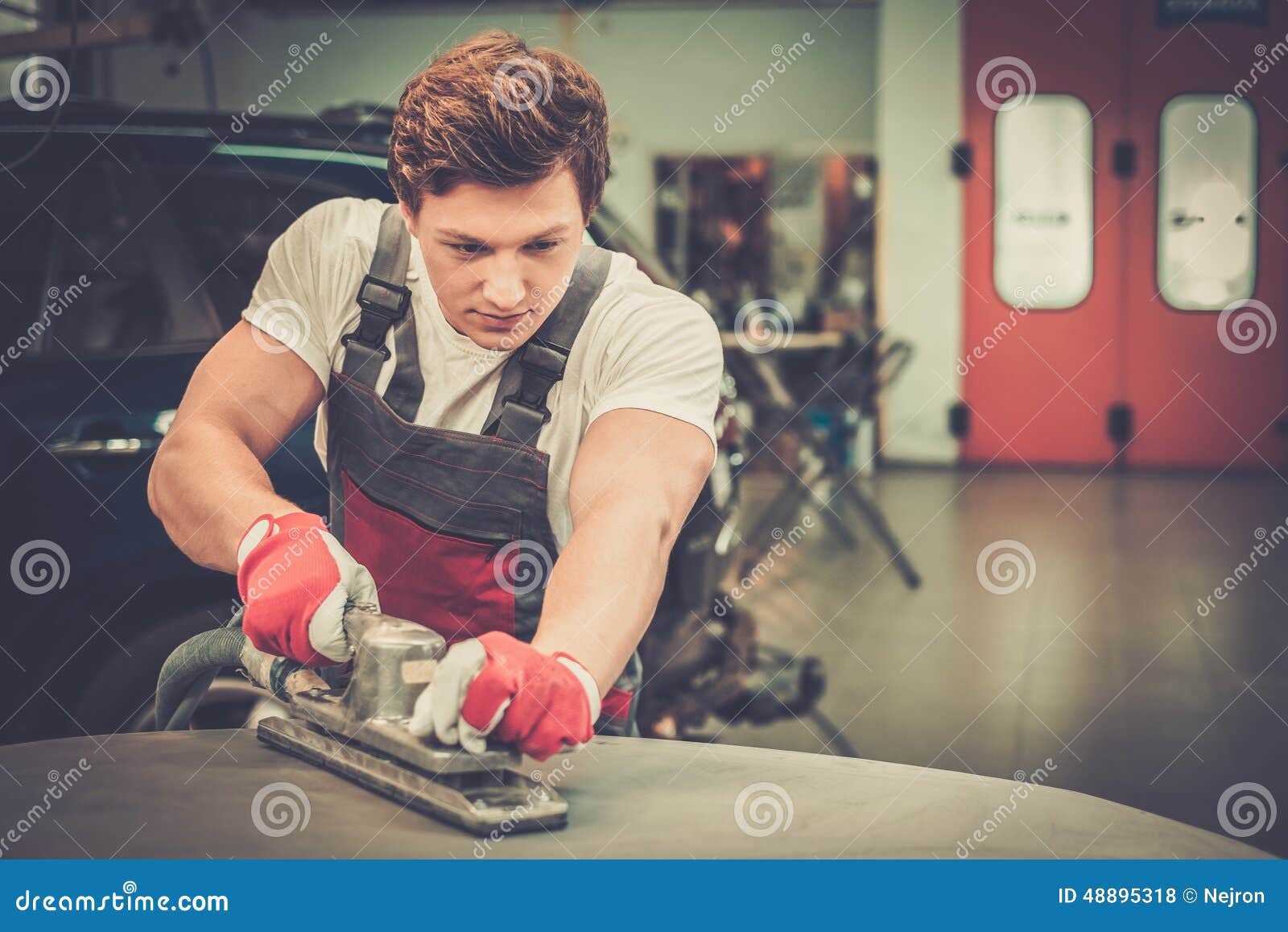Serviceman in a Car Workshop Stock Photo - Image of people, machine ...