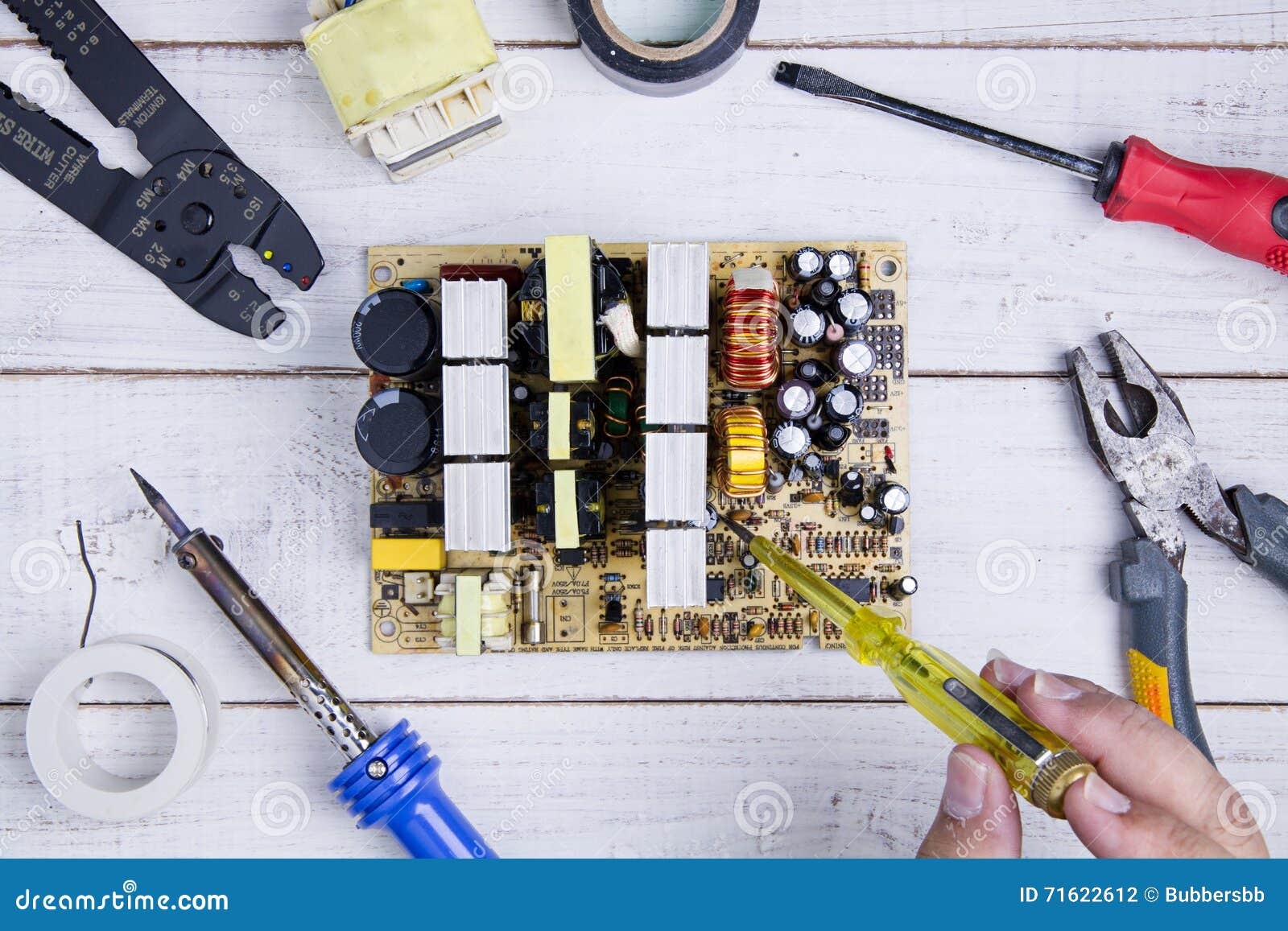 Serviceman Check Circuit Board with Electrical Tester Screwdriver in ...