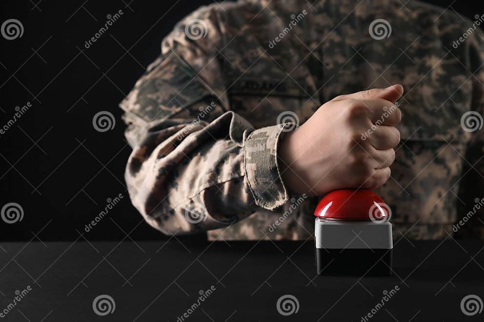 Serviceman Pressing Red Button of Nuclear Weapon at Black Table ...