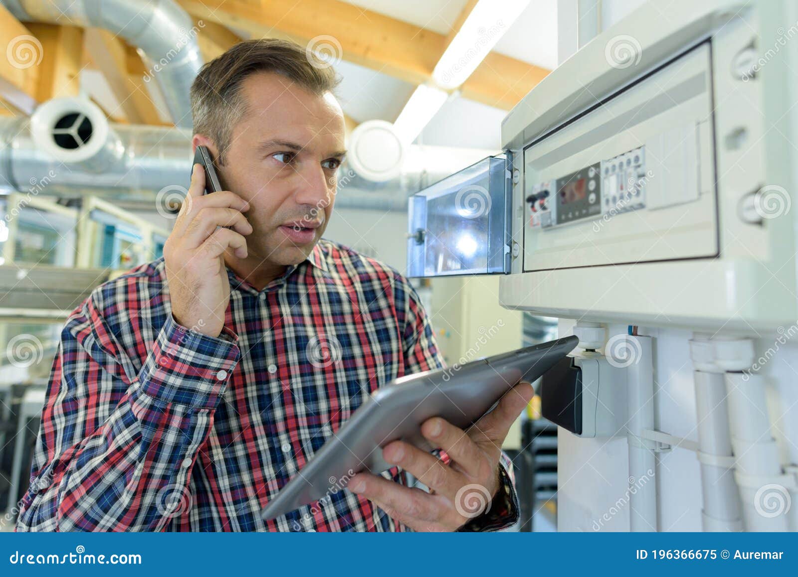 Serviceman on Telephone by Electronic Control Panel Stock Image - Image ...