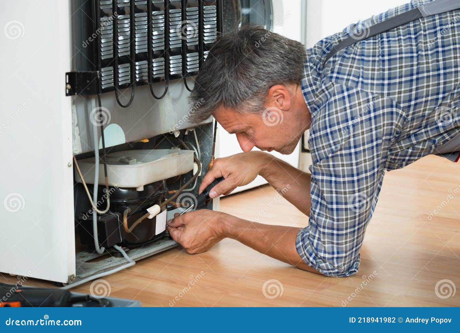 Serviceman Working on Fridge at Home Stock Photo - Image of house ...