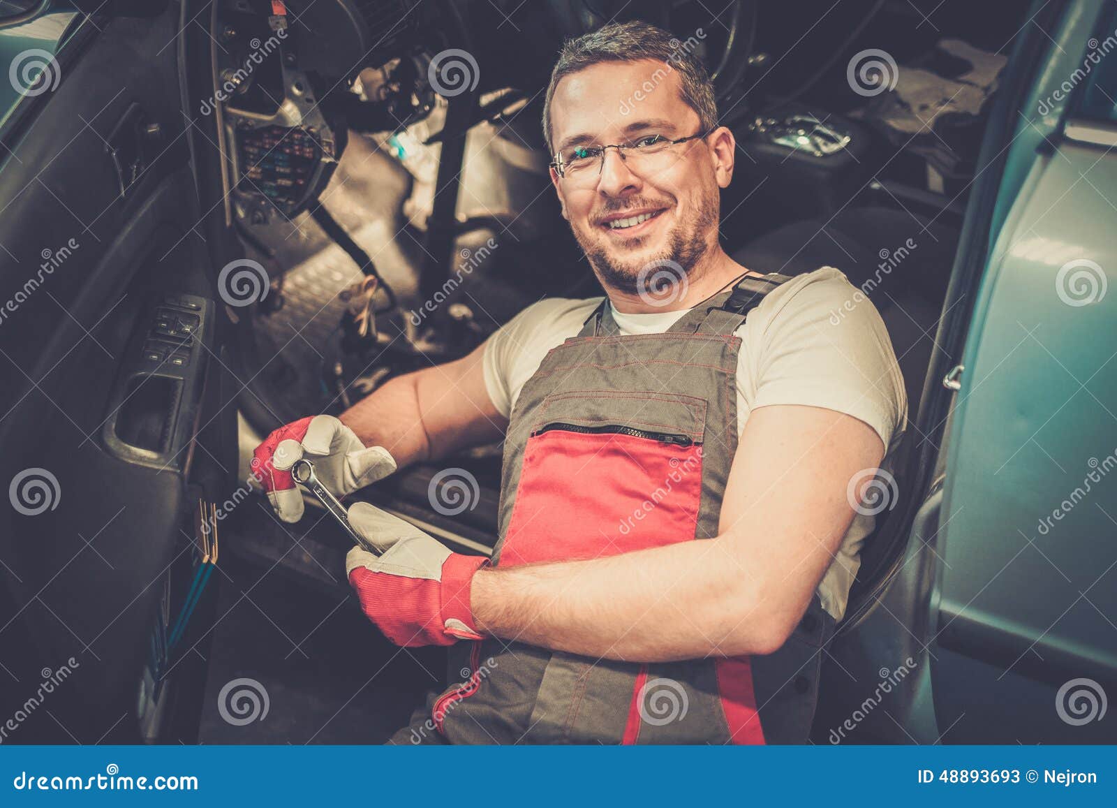 Serviceman in a workshop stock image. Image of inspection - 48893693