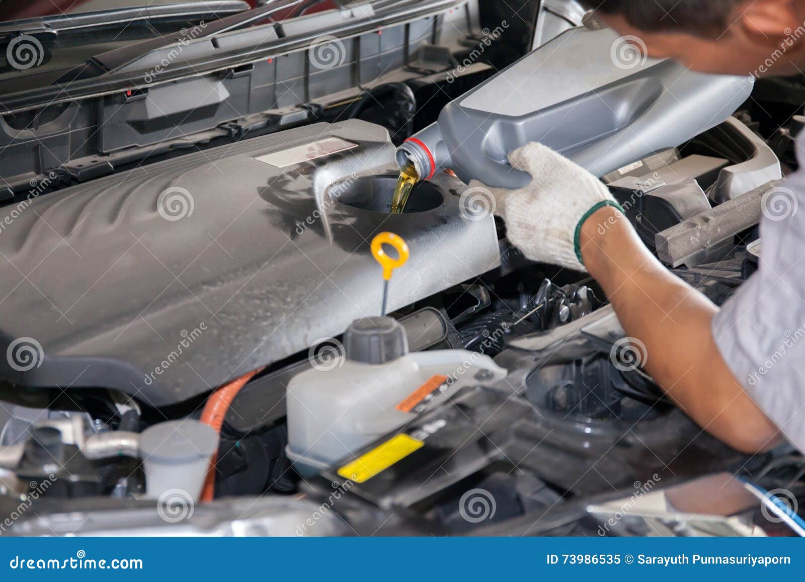 Servicing Mechanic Pouring New Oil Lubricant into the Car Engine Stock ...