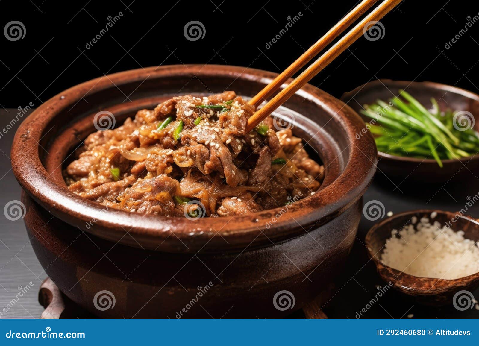 Serving Bulgogi with a Spoon from a Stone Pot Stock Photo - Image of ...
