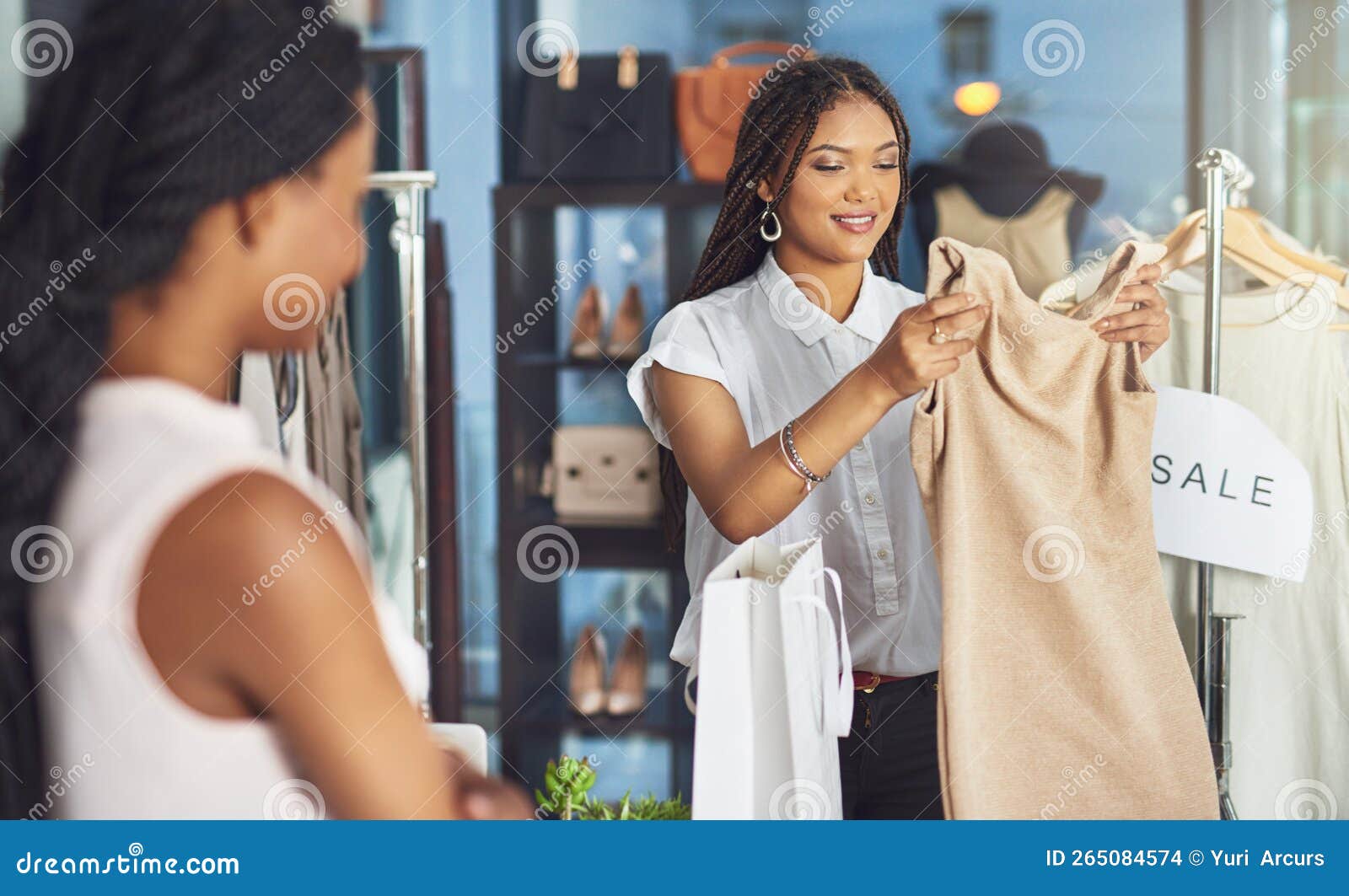 Serving One of Her Regular Shoppers. a Shop Assistant Packaging a ...