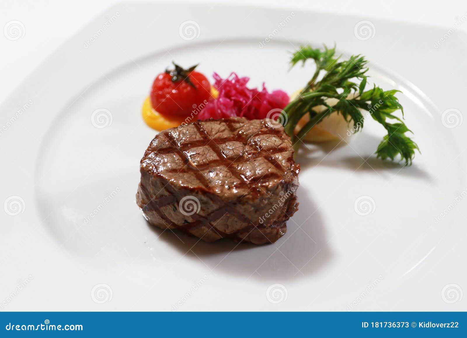 Serving a Steak on a White Plate with Tomato, Vegetables Garnish ...