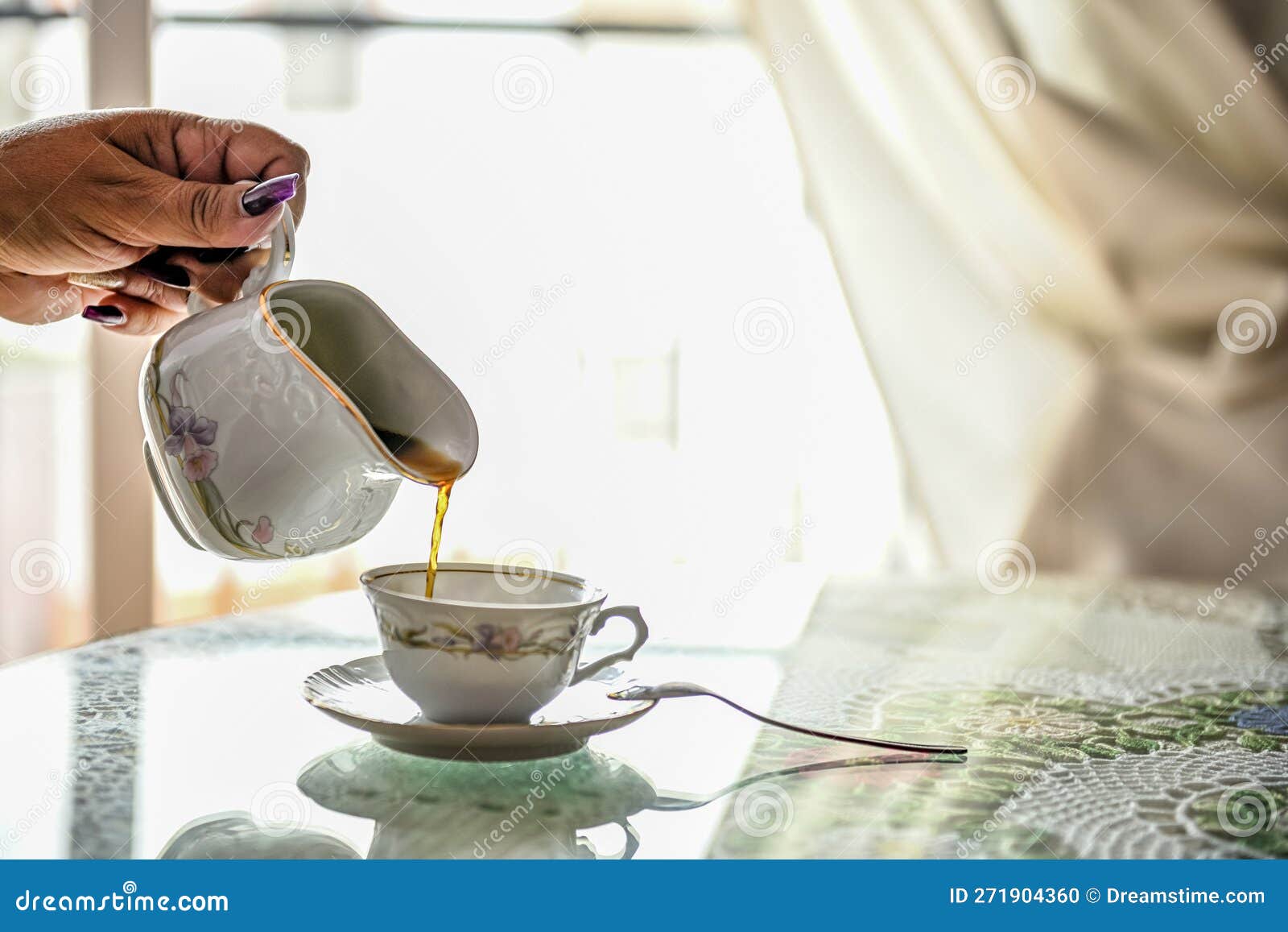 Serving the Tea in a Glass Cup, on a Table. Natural Bright Background ...