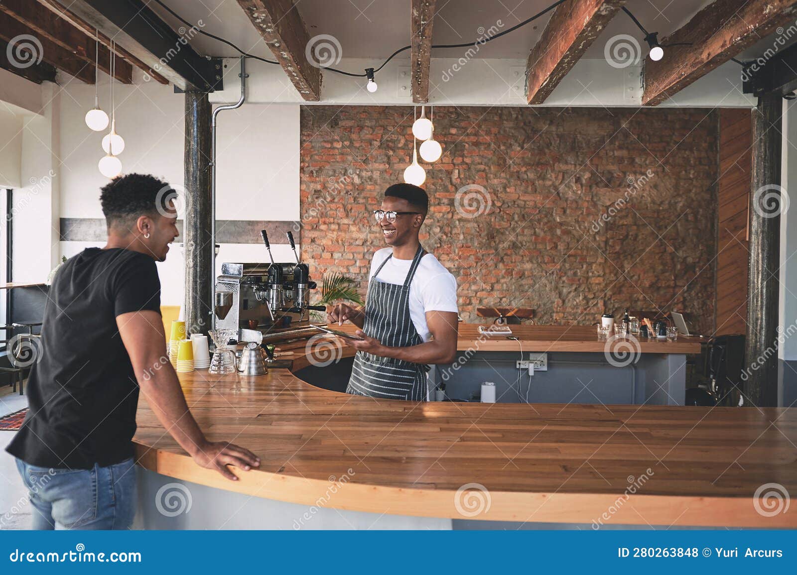 Serving Up a Lot of Laughs. a Young Man Using a Digital Tablet while ...