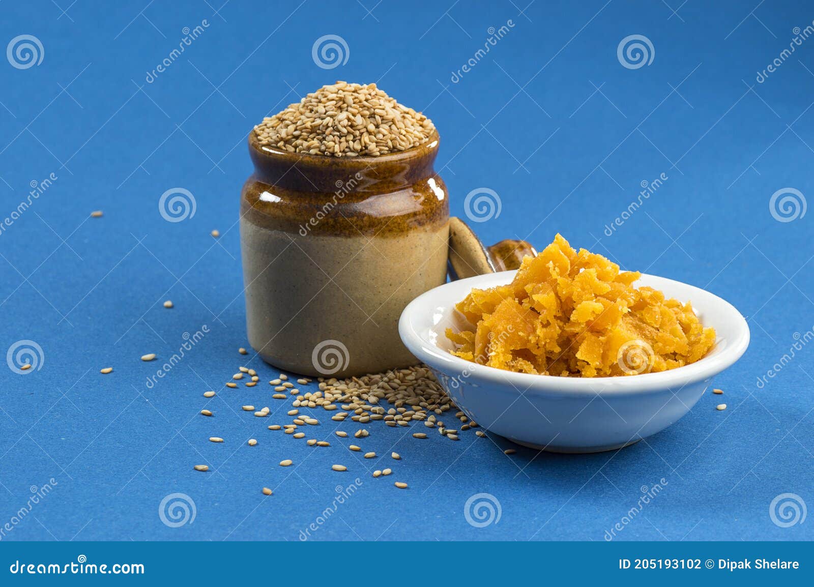 Sesame Seeds in Clay Pot with Jaggery in Bowl on Blue Background Stock ...