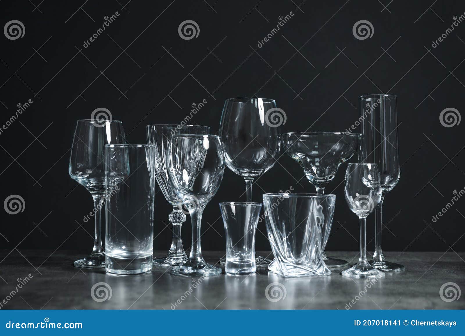 Set of Bar Glassware on Table Against Dark Background Stock Image ...