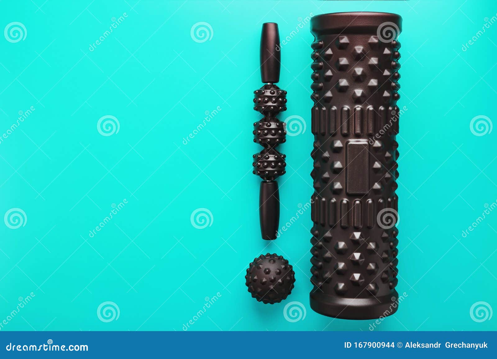 A Set Of Black Bumpy Foam Massage Rollers Body Rollers Rubber Balls On A Blue Background Stock