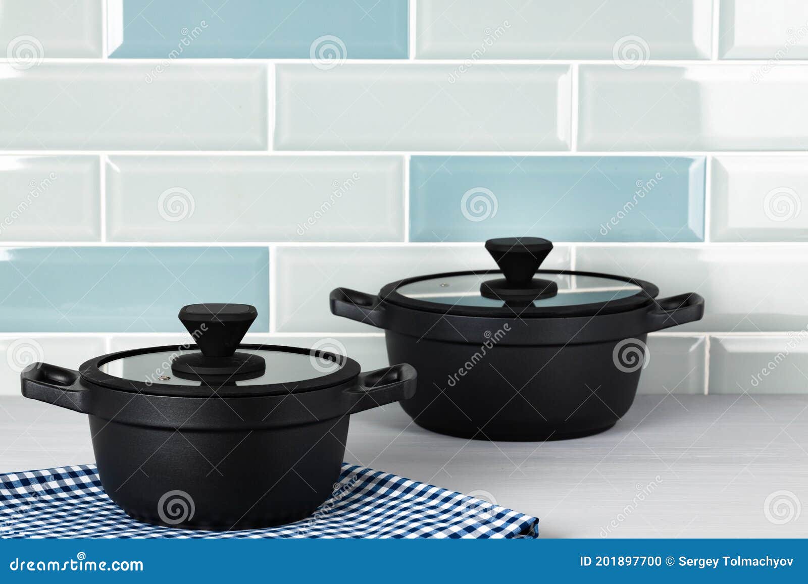 Set of Black Cookware on Kitchen Counter Stock Photo - Image of ...