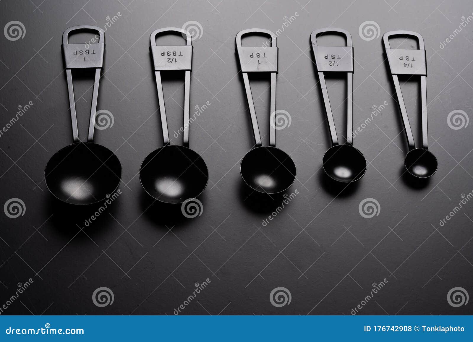 A Set of Black Measuring Spoon on Black Background Stock Photo - Image ...