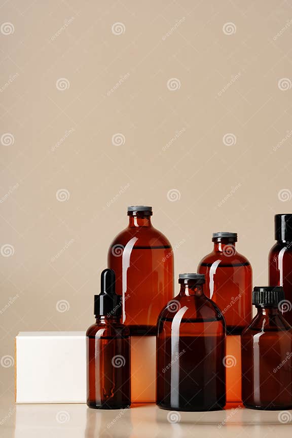 Set Of Brown Glass Bottles With Essential Oils On Stand On Beige Background Stock Image Image