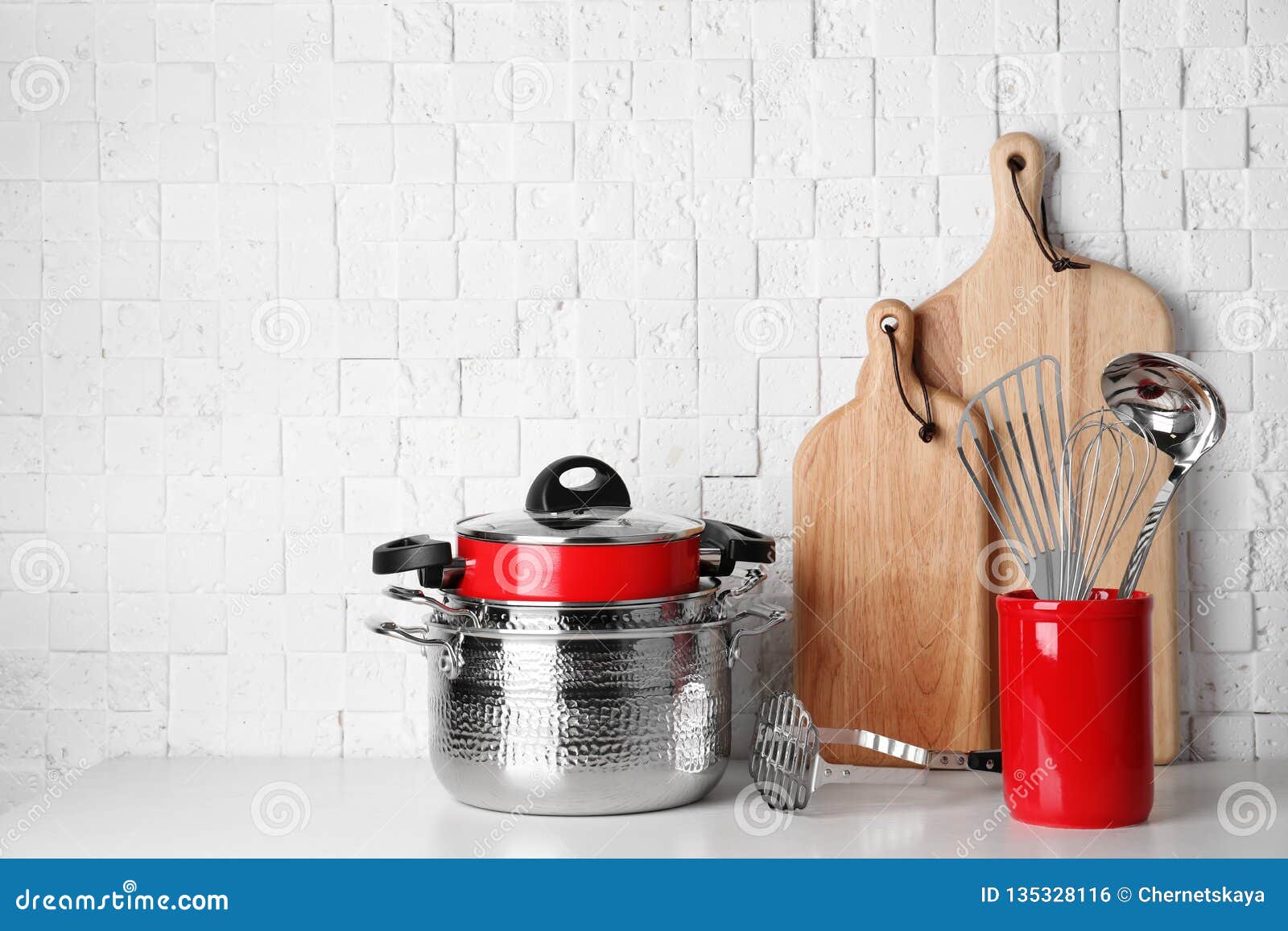 Set of Clean Cookware and Utensils on Table Against White Wall Stock ...
