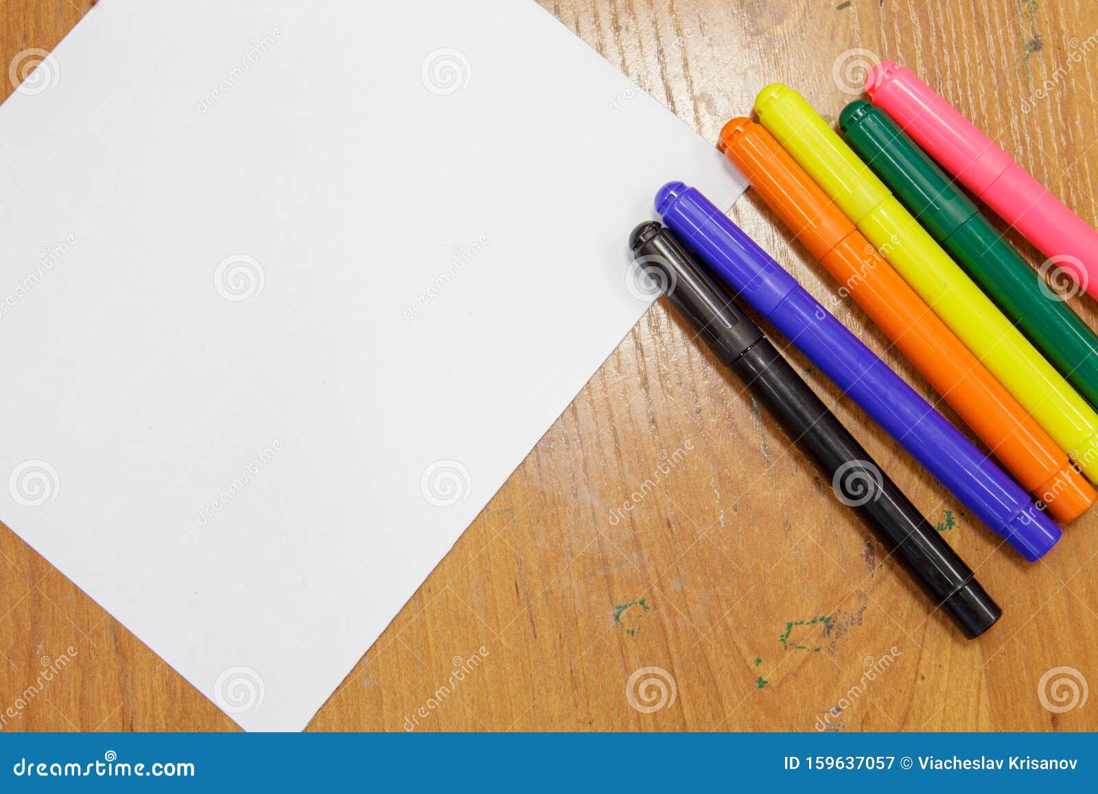 A Set of Colored Markers and a Sheet of White Paper on the Table. Stock ...