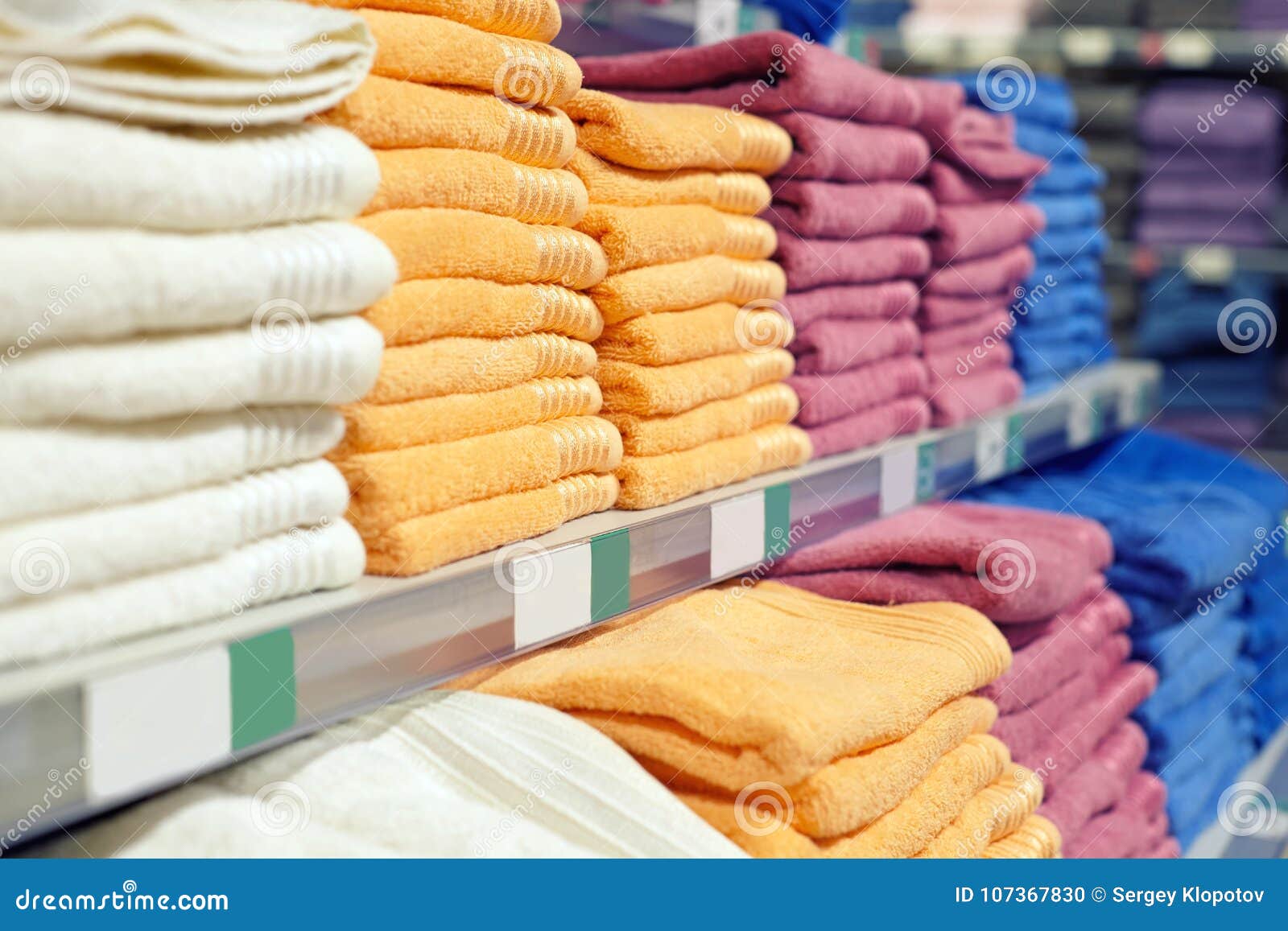 A Set of Colored Towels on a Shelf in a Store. Stock Photo - Image of ...