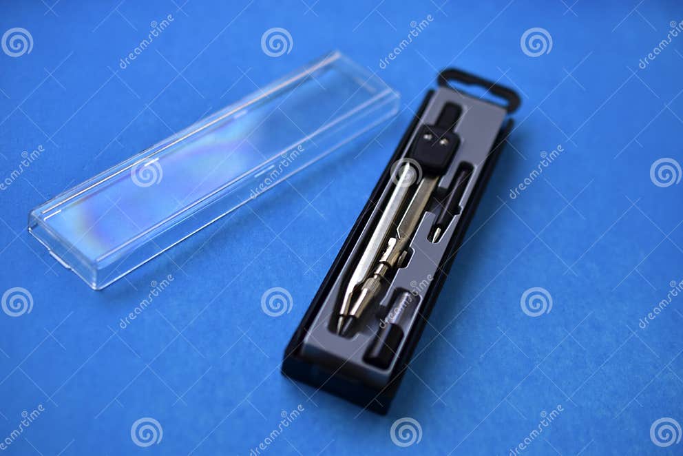 Set of Compasses in a Box on a Blue Background Stock Photo - Image of ...