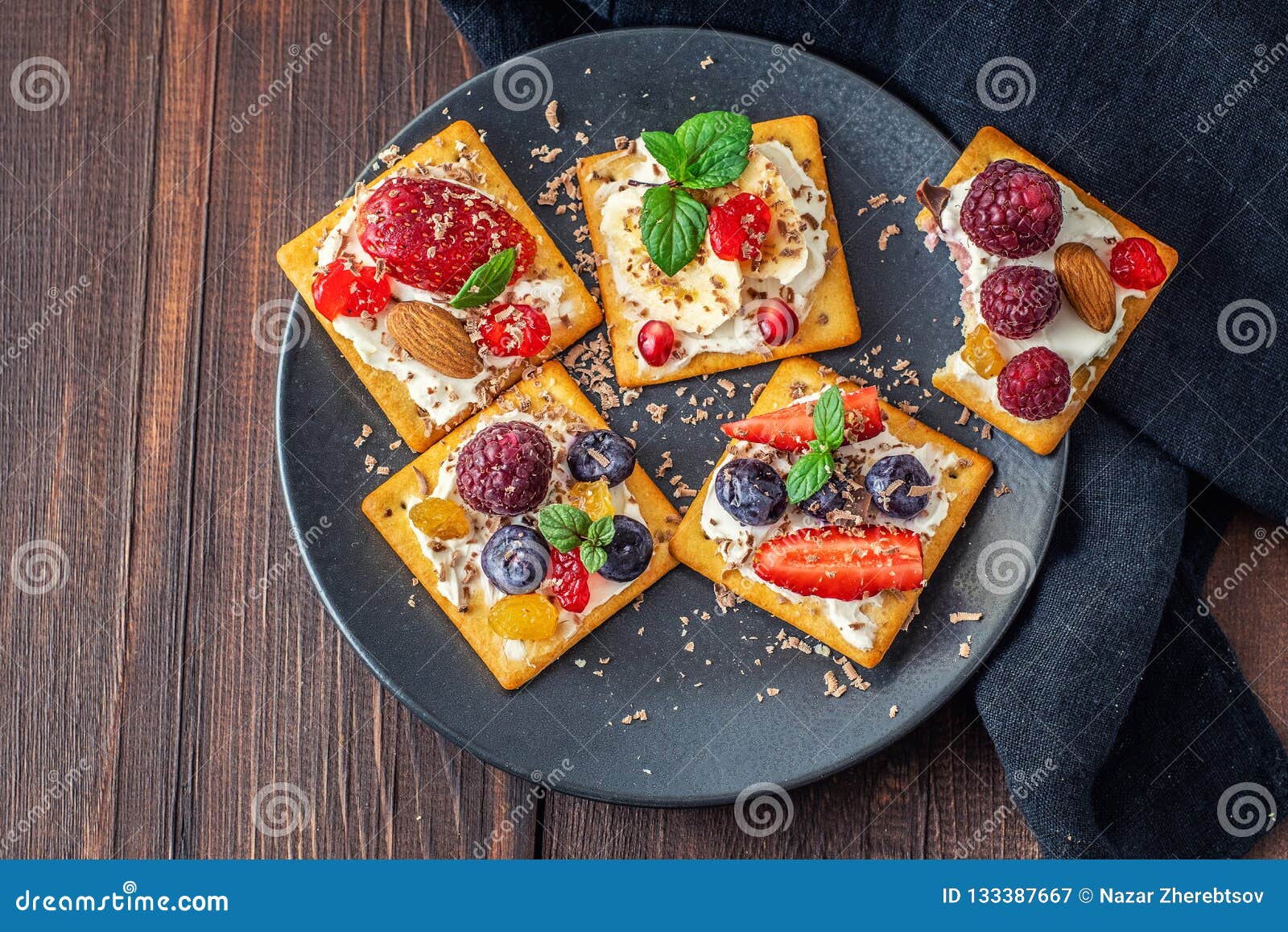 Set of Crackers with Various Fruit Close-up on Dark Wooden Table. Top ...