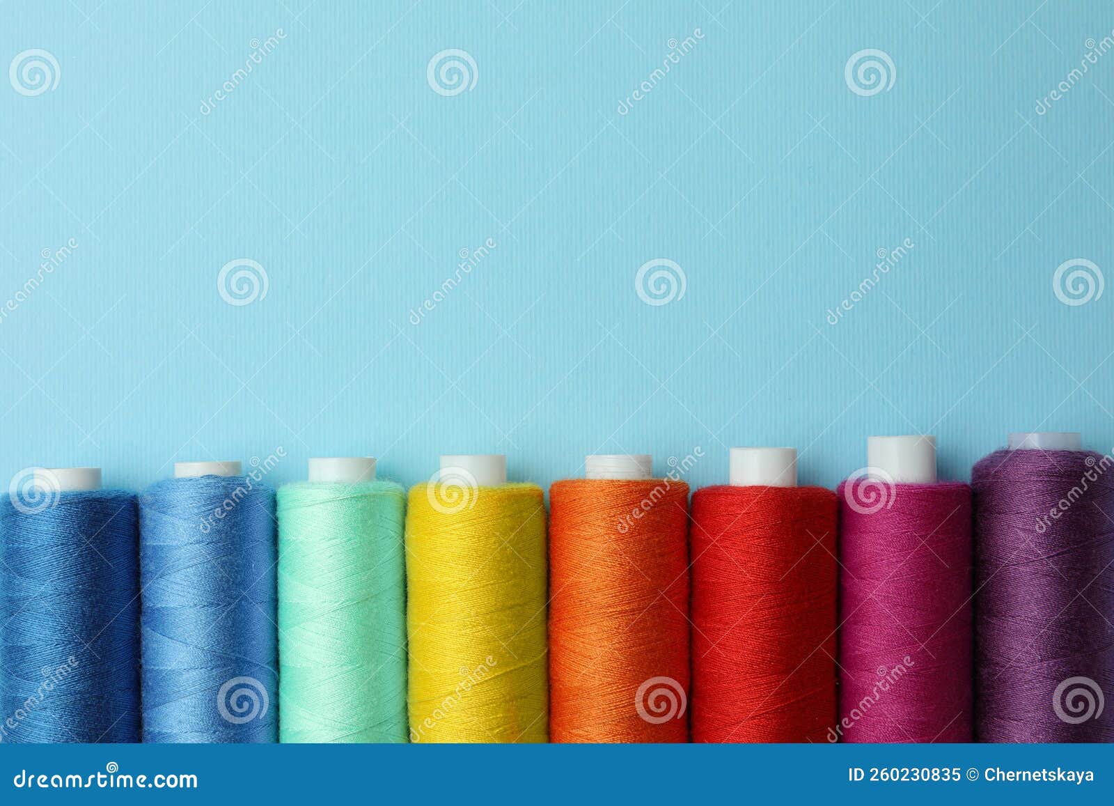 Set of Different Colorful Sewing Threads on Light Blue Background, Flat ...