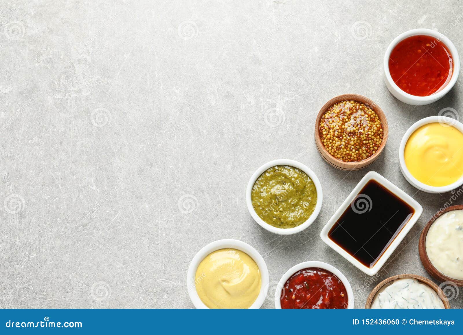Set of Different Delicious Sauces on Grey Table. Space for Text Stock ...
