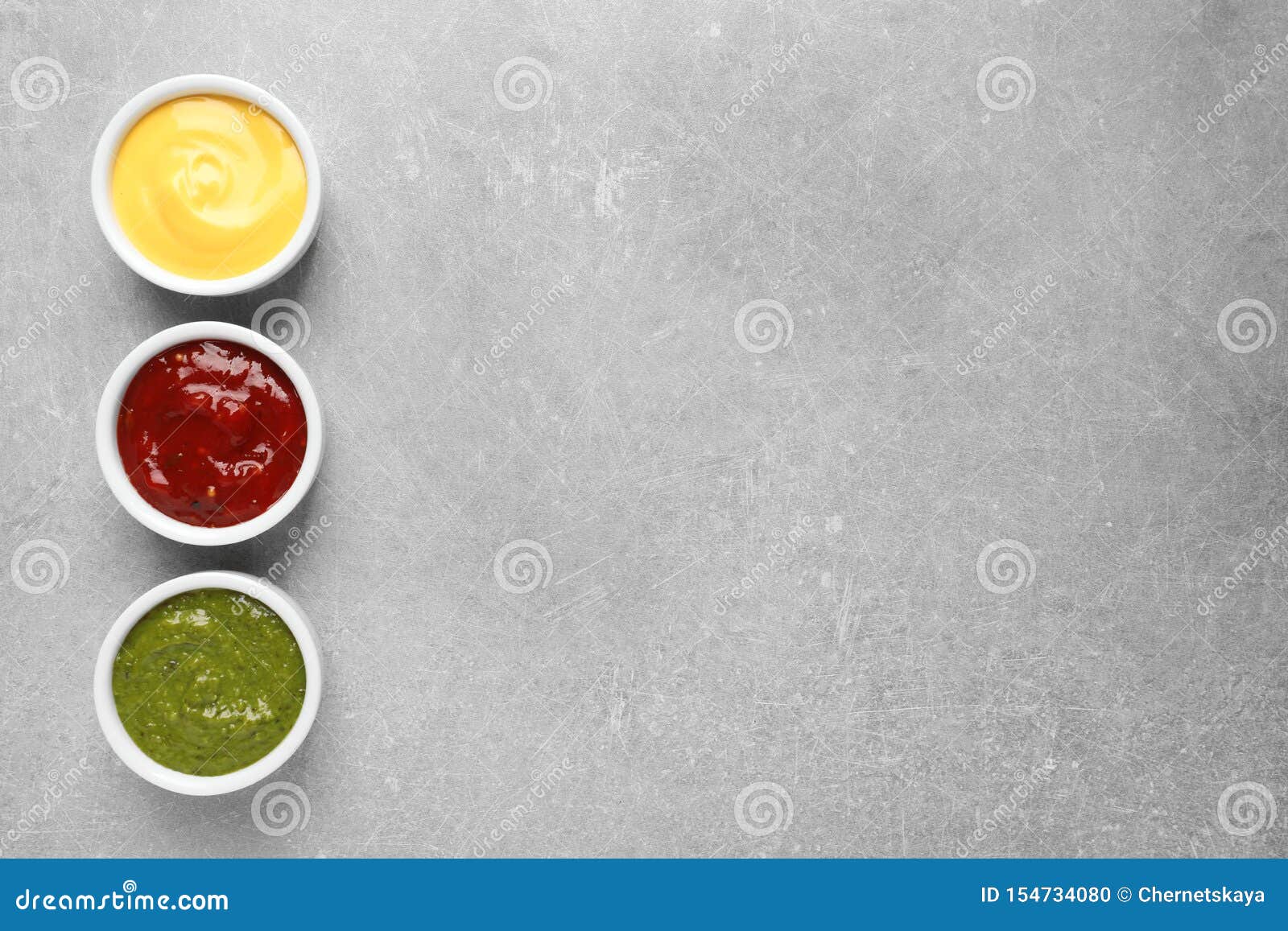 Set of Different Delicious Sauces on Grey Table, Top View. Space for ...