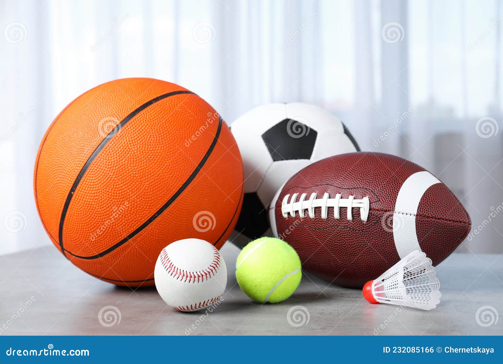 Set of Different Sport Balls and Shuttlecock on Light Grey Table Stock ...