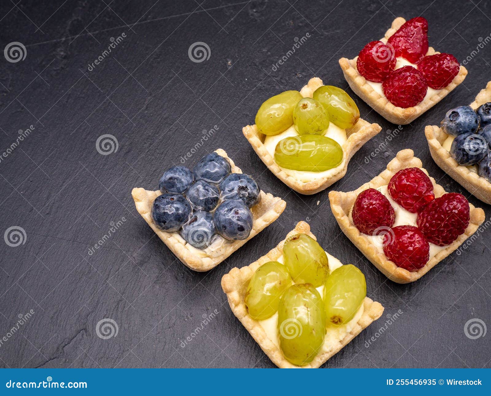 Set of Different Tarts with Berries on a Black Surface Stock Image ...