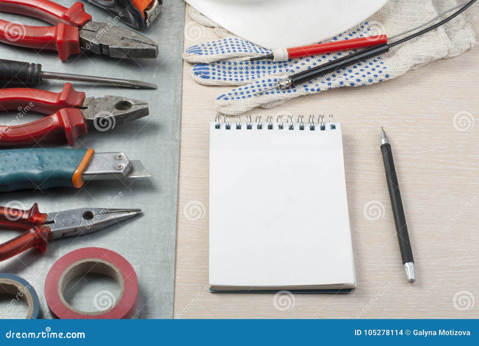 .Set of Electrical Tools, White Helmet and Notepad on Metallic ...