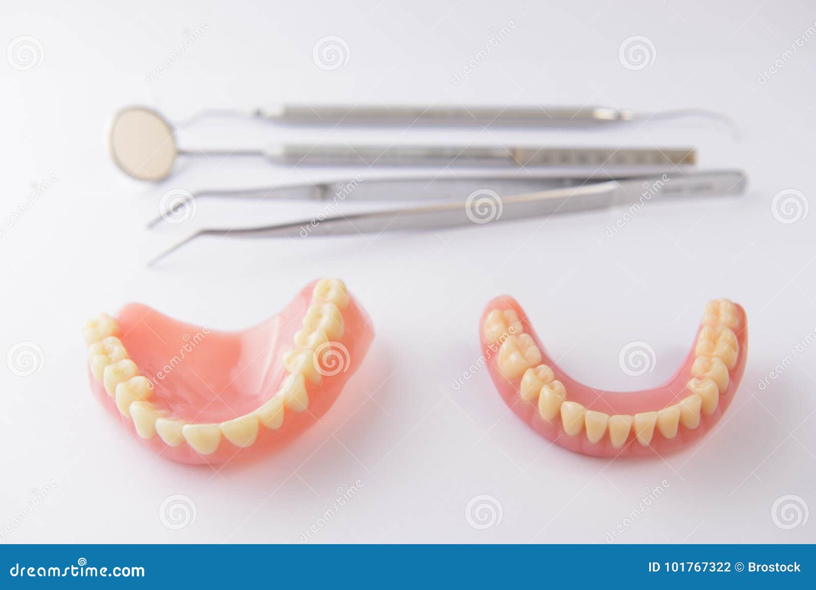 Set of False Teeth and Dental Tools on White Background Stock Photo ...