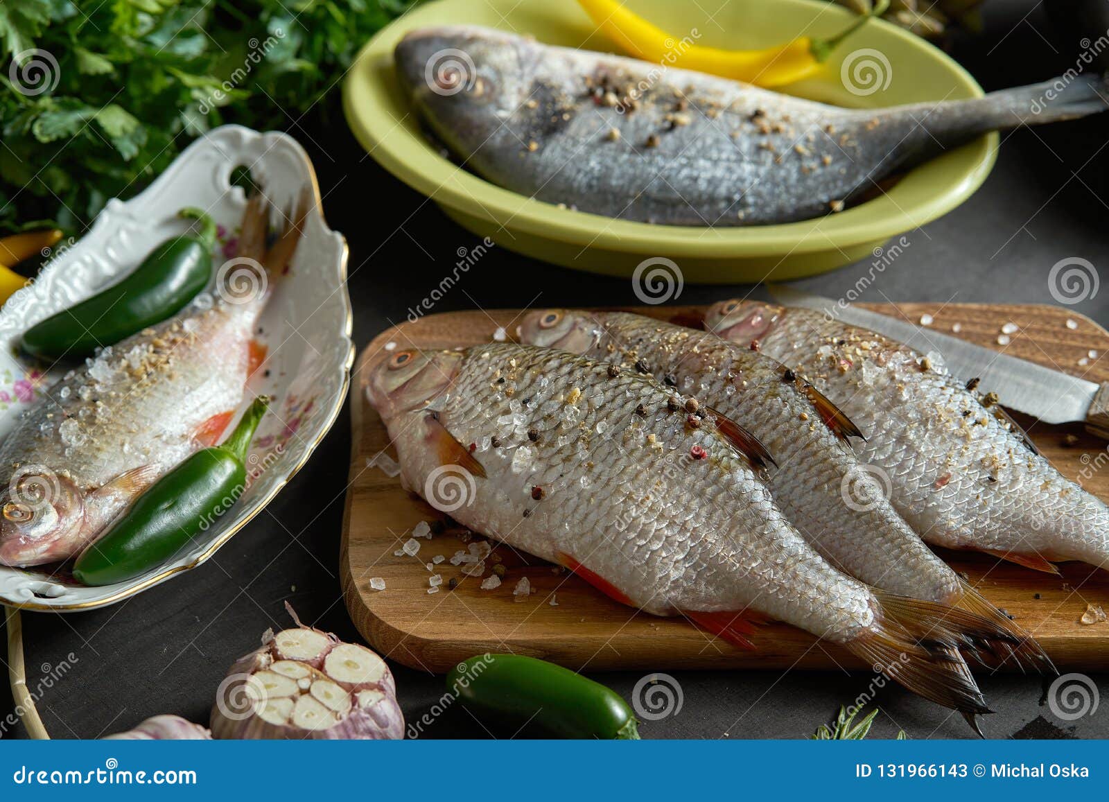 A Set of Fresh, Raw Fish in Various Dishes and with Vegetables on a ...